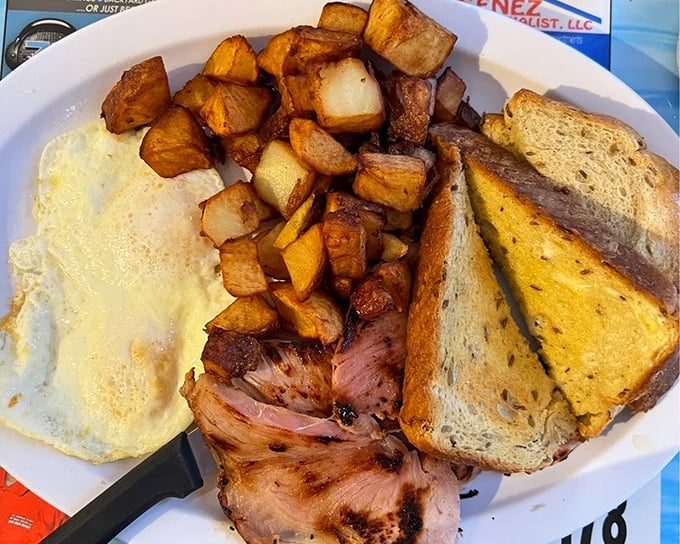 Breakfast that doesn't mess around—home fries crisped to perfection, eggs sunny as Florida itself, and ham that means business.