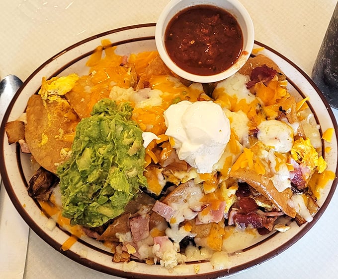 Breakfast nachos: where morning ingredients crash a late-night party. The guacamole crown jewel proves some rules are meant to be deliciously broken.