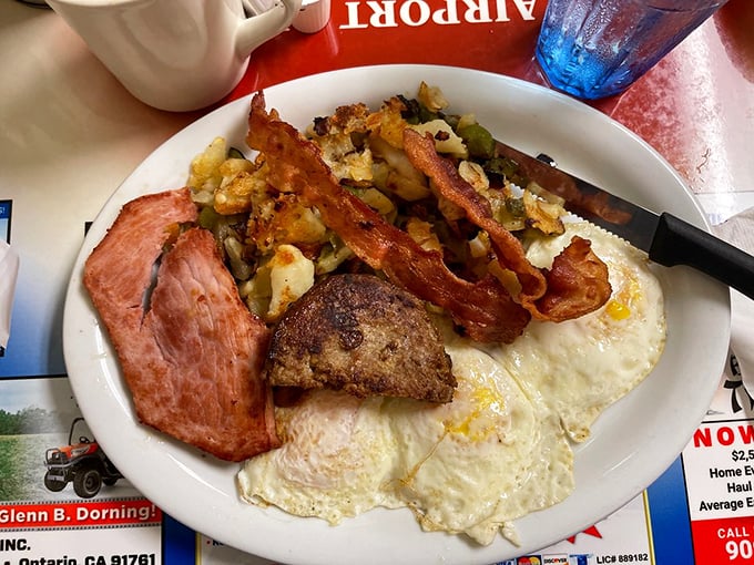 The breakfast plate that launched a thousand satisfied sighs—eggs, bacon, sausage, and potatoes in perfect harmony like a culinary barbershop quartet.