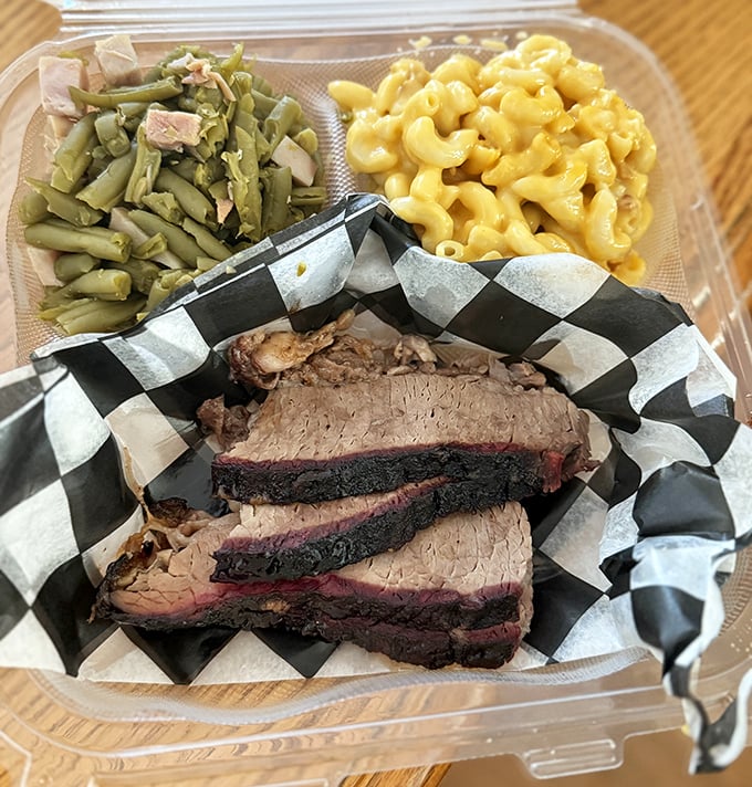 The brisket's bark is like nature's candy, paired with green beans and that legendary mac and cheese—a balanced meal if you squint hard enough.
