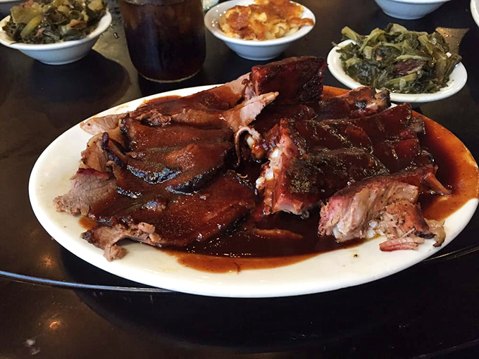 Barbecue plated on a vibrant red dish—because even the plateware knows this is food worth celebrating. Meat candy for grown-ups.
