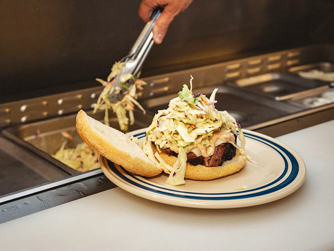 A sandwich that requires both hands and several napkins – the hallmark of authentic barbecue that doesn't apologize for being messy.