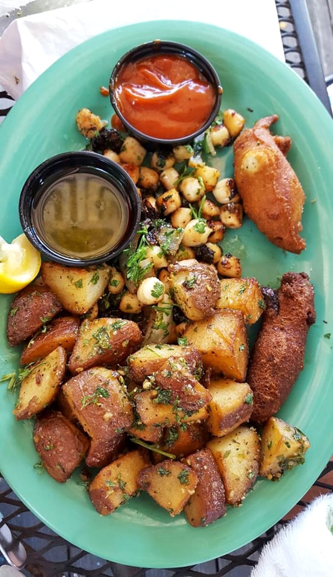 This isn't just a plate—it's a treasure map of flavors with potatoes, scallops, and dipping sauces that'll have you plotting your return visit.