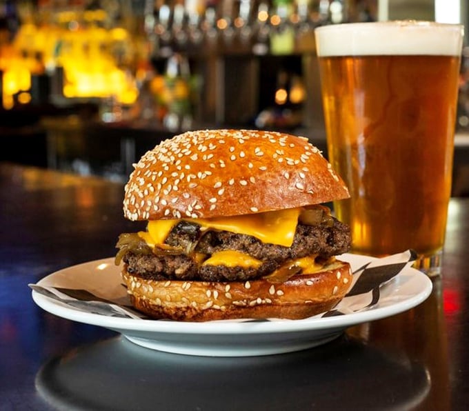 This isn't just a burger—it's a masterpiece of beef, cheese, and sesame-studded bun that pairs perfectly with that amber pint of liquid happiness.
