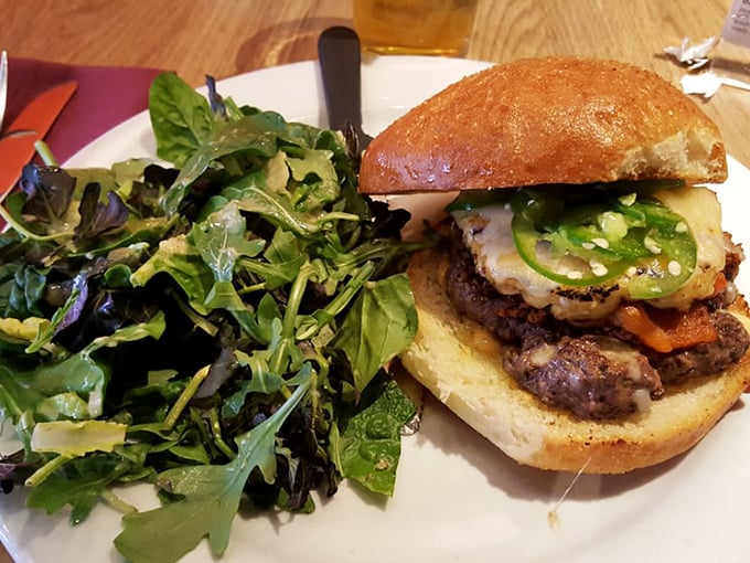 This isn't just a burger, it's an architectural marvel of beef, jalapeños, and melty cheese on a golden bun that demands both hands and your full attention.