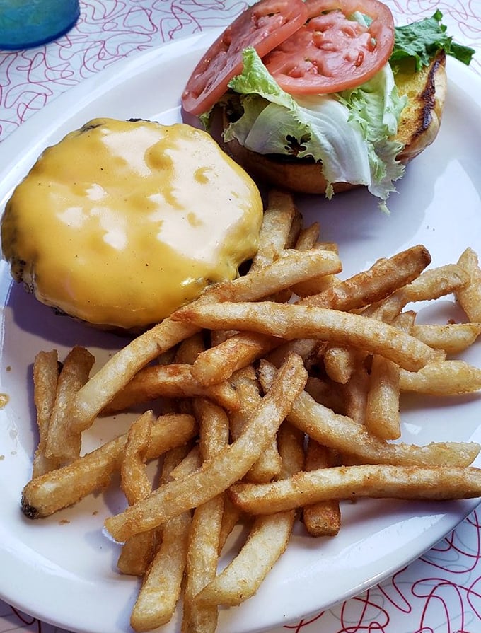 The cheeseburger here doesn't need fancy aioli or artisanal buns to impress—just perfectly melted American cheese, fresh veggies, and fries that snap when you bite them.