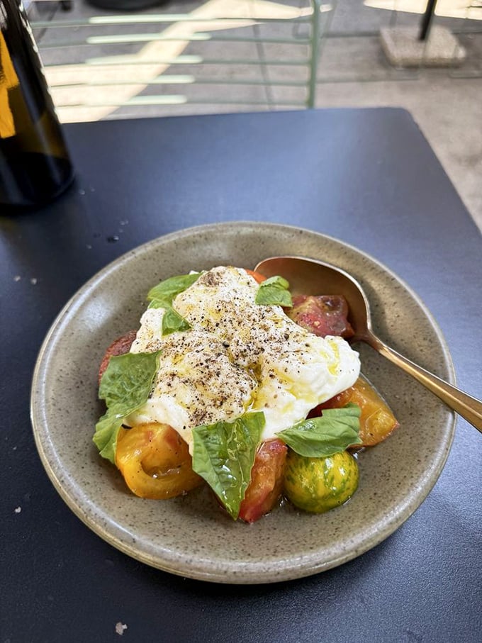 The burrata salad—where fresh cheese meets heirloom tomatoes in a summer romance so perfect it deserves its own Italian love song.