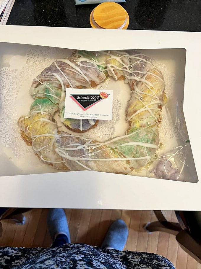 A donut wreath fit for royalty. The kind of centerpiece that makes guests wonder if they're allowed to eat it or just admire its frosted glory.