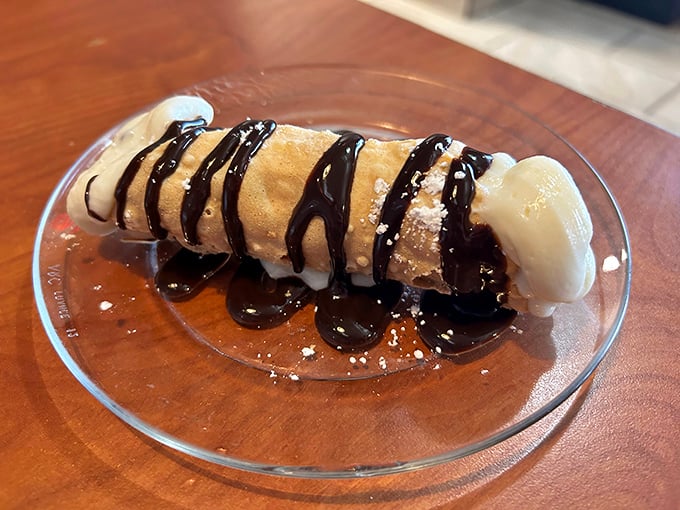 The cannoli shell maintains that crucial crispness while chocolate sauce zigzags across the top like an Italian expressway.