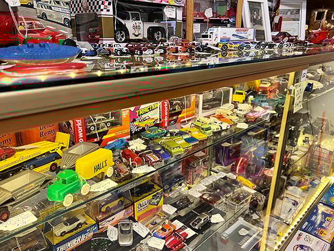 Miniature automotive history behind glass – from classic Americana trucks to racing legends, each tiny vehicle carries outsized memories of simpler times.