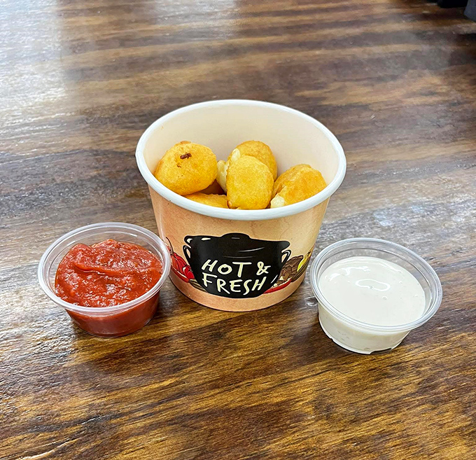 Golden cheese curds with dipping sauces that make you question why anyone would ever eat at a chain restaurant again. Simple perfection in a paper container.