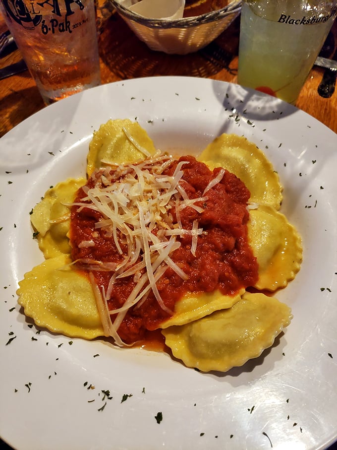 Ravioli islands floating in a sea of robust tomato sauce – pasta pillows that comfort your soul while challenging your restraint.
