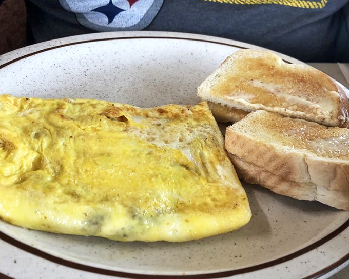The perfect omelet isn't just about technique—it's about generosity, as demonstrated by this fluffy yellow pillow of breakfast joy.