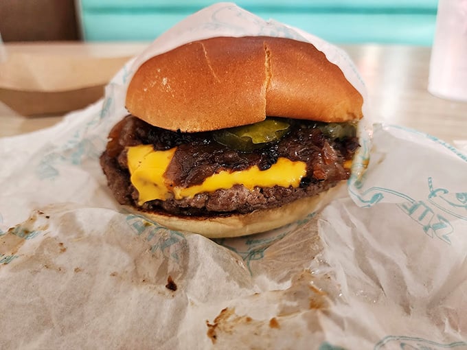 This isn't just a cheeseburger; it's a masterclass in American comfort food – melty cheese cascading over a perfectly seared patty.