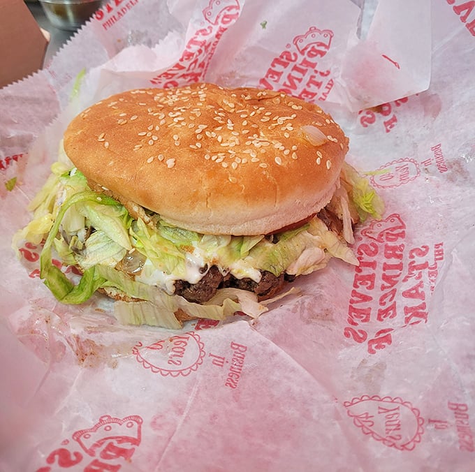 The cheeseburger holds its own in cheesesteak country, a hefty handful of beef and toppings on a sesame-speckled throne.