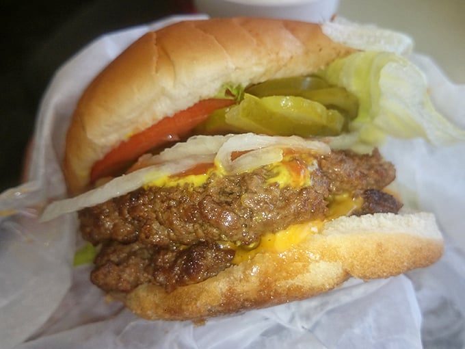 The cheeseburger that launched a thousand road trips. Notice how the pickles and onions aren't hiding—they're proud supporting actors in this meaty drama. 