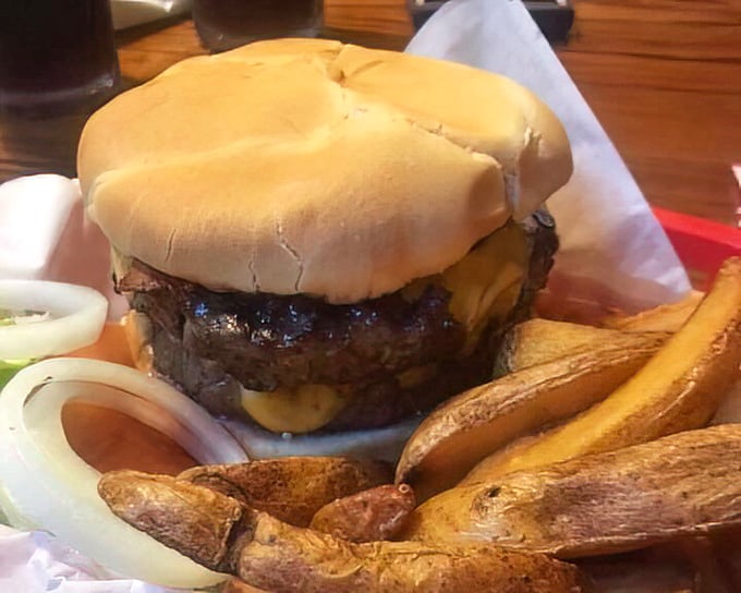 When a burger stands this tall, it's not just lunch—it's an achievement. Those steak fries look like they're auditioning for a supporting role.