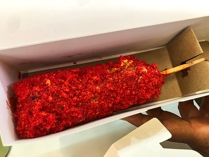 This isn't your ballpark hot dog—it's a Korean rice dog coated in fiery Cheetos crumbs, the culinary equivalent of fireworks.