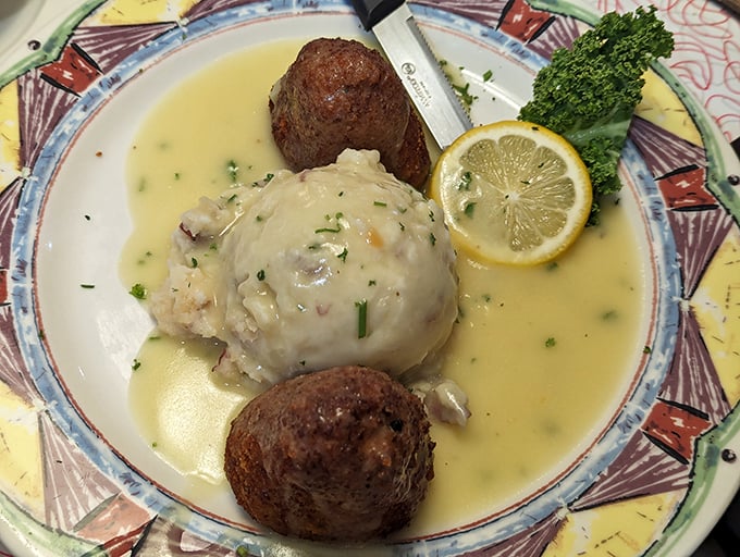 Comfort food elevated to art form—tender chicken nestled in lemony sauce with perfectly formed meatballs standing guard on the perimeter.