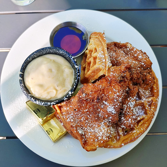 Golden waffles playing the perfect sweet foundation to crispy chicken – with maple syrup and gravy standing by like delicious diplomatic liaisons between opposing flavor nations.