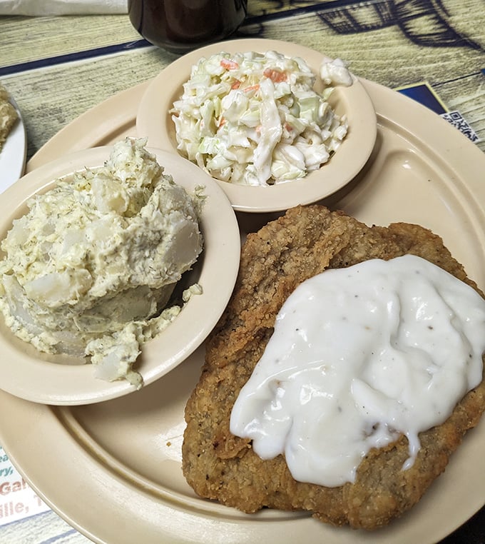 Country fried steak with white gravy alongside potato salad and coleslaw – a Southern trinity that could convert even the most devoted health nut.