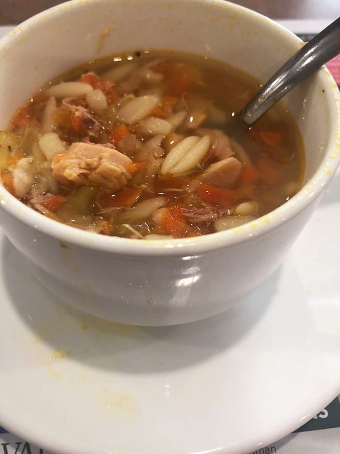 A bowl of chicken noodle soup that would make your grandmother nod in approval—chunky vegetables, tender chicken, and pasta swimming in liquid comfort.