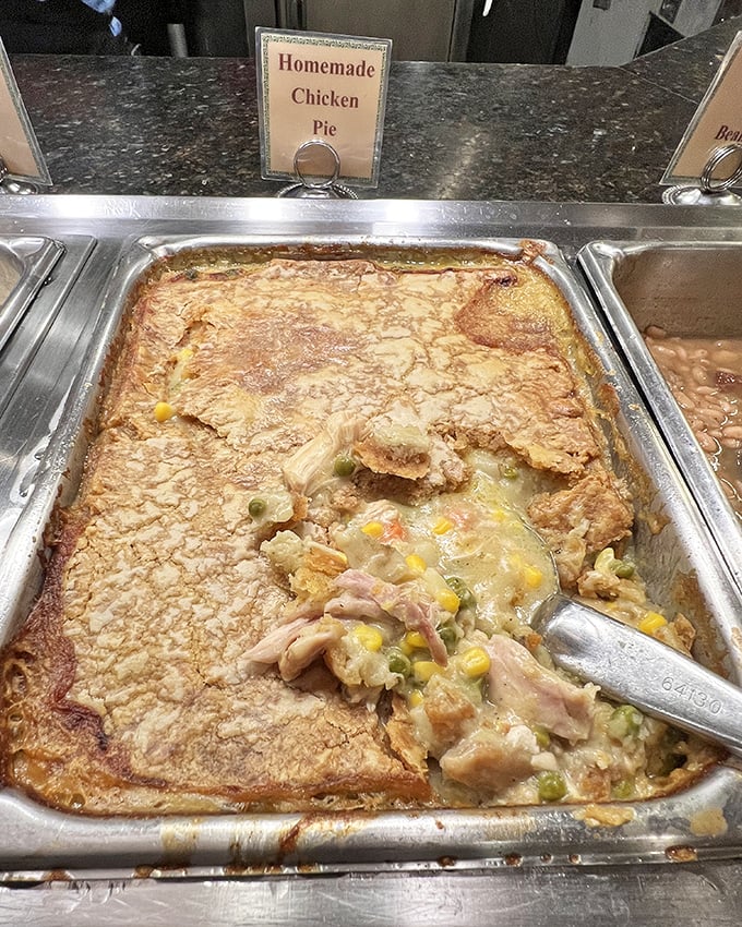 The chicken pot pie isn't just comfort food—it's a golden-crusted time machine to your grandmother's kitchen, complete with visible chunks of chicken and vegetables.