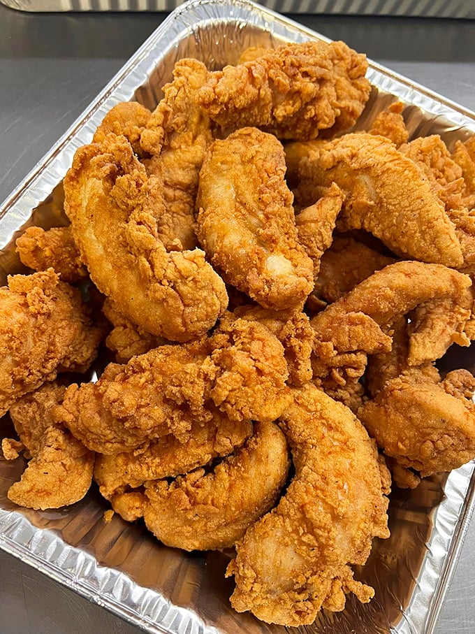 Chicken tenders that could convert even the most dedicated wing enthusiast—juicy white meat encased in a golden armor of perfectly seasoned breading.