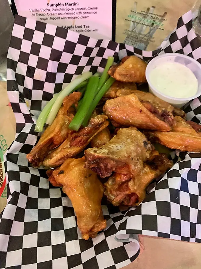Wings that arrive looking like they've been to finishing school – perfectly crisp, glistening with sauce, and chaperoned by fresh celery.