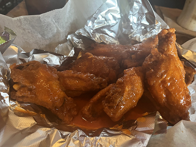Wings that would make Buffalo proud. Glistening with sauce and nestled in foil—these aren't just appetizers, they're the reason napkins were invented.