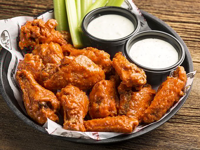 Buffalo wings that don't mess around—crispy, saucy, and accompanied by cooling dips that know their supporting role.