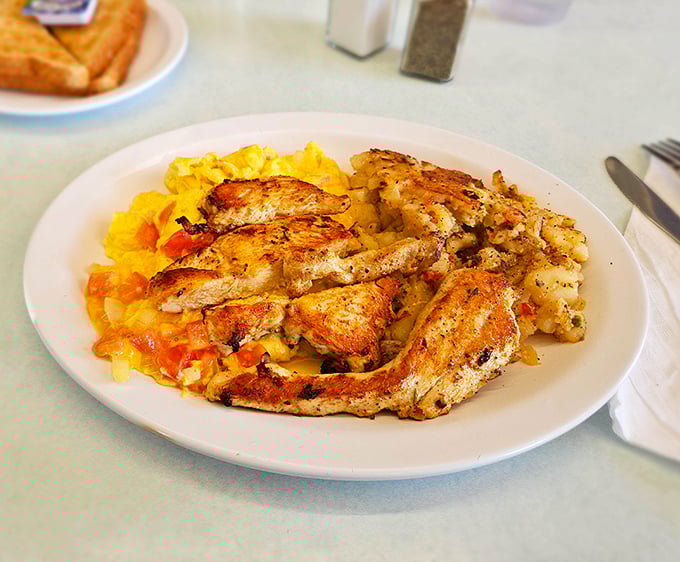 Grilled chicken nestled into fluffy eggs with perfectly sautéed vegetables – breakfast and lunch having a delicious identity crisis.