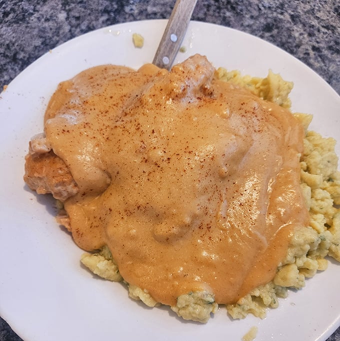Chicken paprikash over scrambled eggs – the kind of hearty plate that makes you want to adopt a Hungarian grandmother immediately.