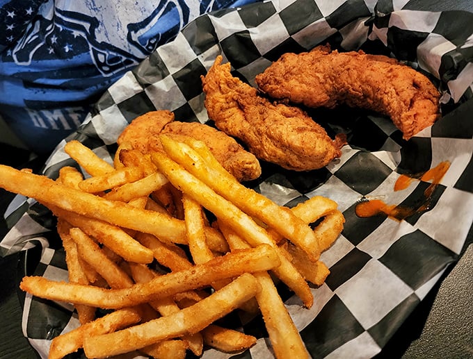 Golden fries and perfectly crisp chicken tenders nestled in a checkered basket—proof that sometimes the simplest pleasures are the most satisfying.