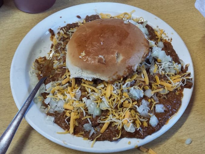 The chili burger doesn't just sit on the plate—it commands attention like a saucy general, marshaling forces of cheese and onions into perfect harmony.