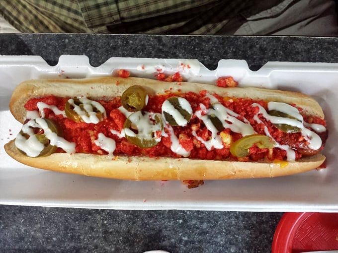Behold the chili dog in its natural habitat—swimming in savory sauce with jalapeños standing guard like spicy sentinels.