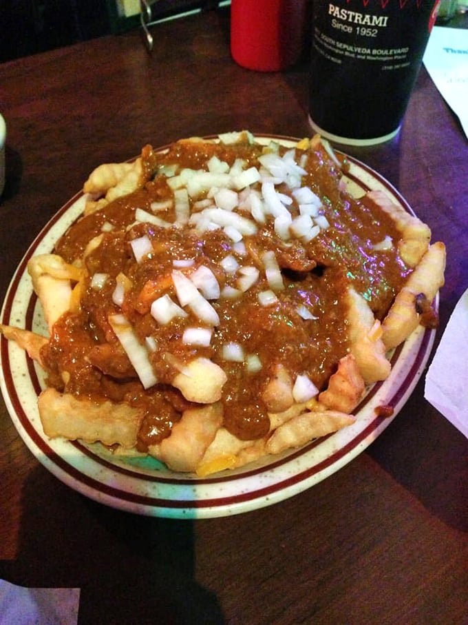 Chili fries that laugh in the face of diet culture. The raw onions add a sharp counterpoint to the rich, beefy chili—pure comfort on a plate.