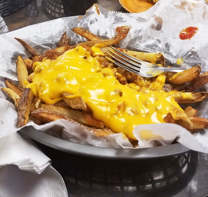 These cheese fries aren't just a side dish – they're a main event, with that perfect cheese-to-potato ratio that scientists should really study.