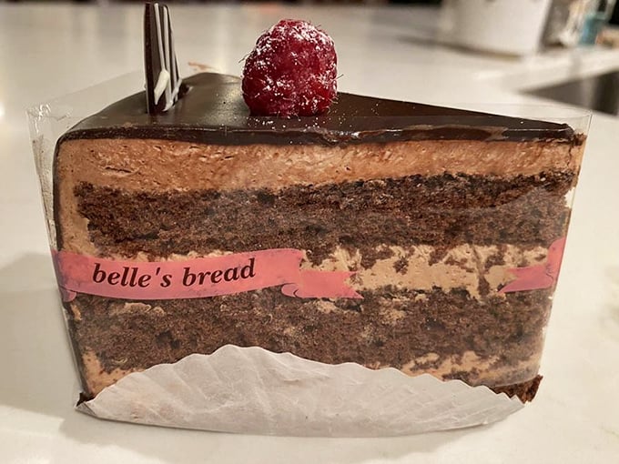 Layer upon layer of chocolate decadence, with Belle's signature pink band – this cake isn't just dessert, it's an architectural achievement.