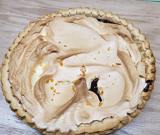 Meringue mountains atop creamy pie valleys – this dessert doesn't just end your meal, it crowns it with a golden halo.