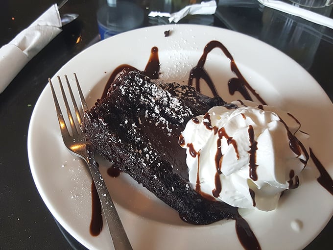 Chocolate cake so decadent it should come with a warning label. That whipped cream isn't a garnish—it's a necessary counterbalance to all that richness.