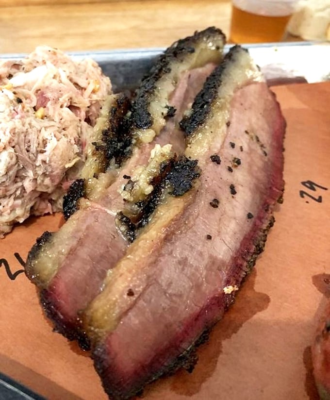 This isn't your average chopped pork – it's barbecue artistry on a plate, with that telltale pink smoke ring of excellence.