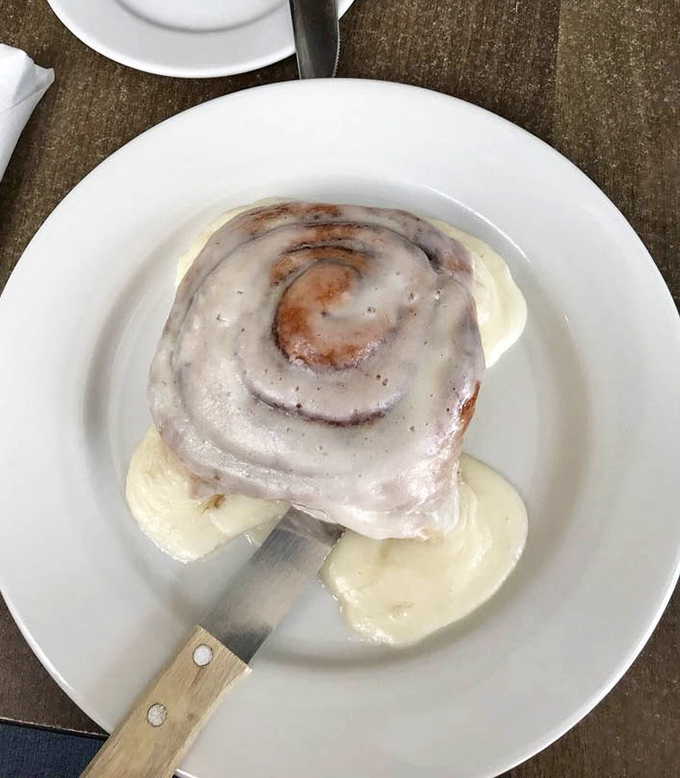 This isn't just a cinnamon roll – it's a spiral-bound love letter to your taste buds, served with a side of banana slices for plausible deniability.
