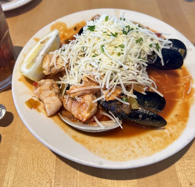 Ocean bounty in a single bowl. This cioppino doesn't just showcase seafood—it tells the story of the fishing boats you can see right outside the window.