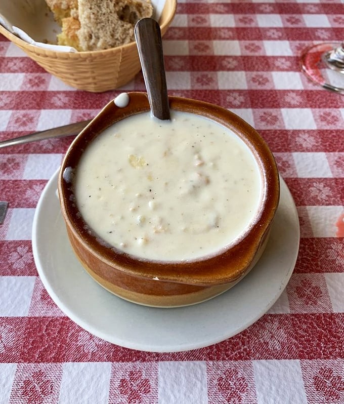 The legendary New England clam chowder arrives like a warm hug in a bowl. Creamy, rich, and studded with tender clams that taste like they were just harvested.