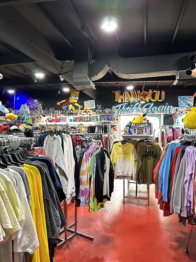 "Thank You, Come Again" reads the sign above a sea of clothing where Bart Simpson watches over shoppers like a cartoon deity.