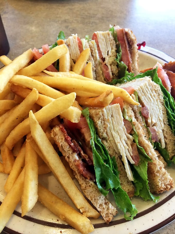 The club sandwich—architecture you can eat, where each layer tells its own delicious story between perfectly toasted bread.