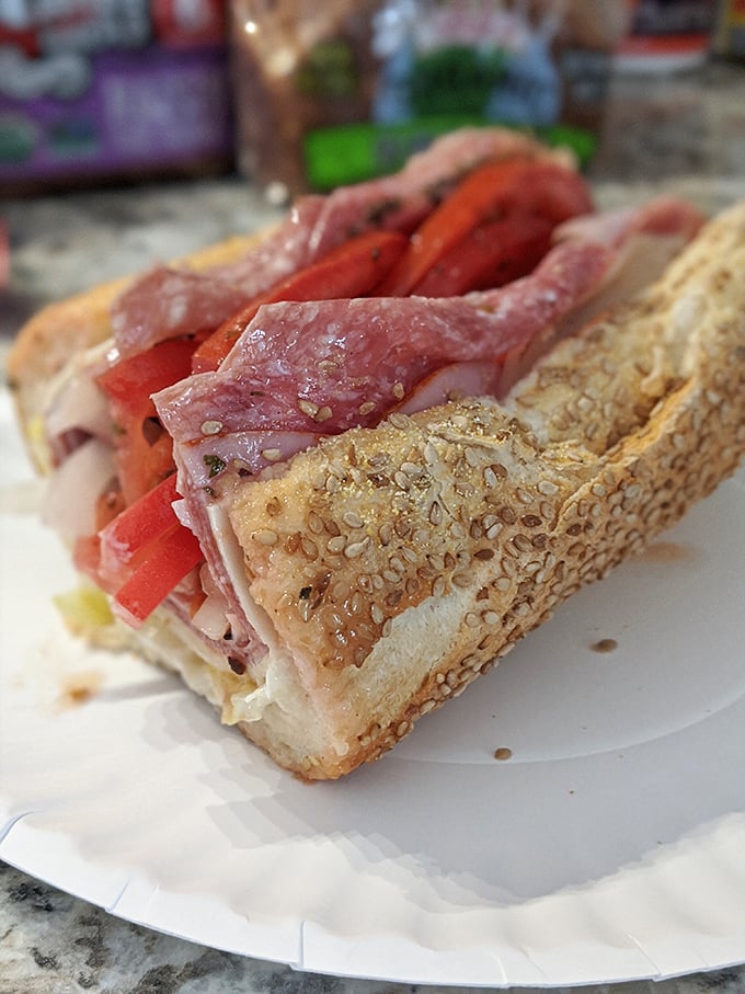 Layer upon glorious layer of cold cuts, fresh vegetables, and that unmistakable sesame-seeded roll—this sub doesn't just satisfy hunger, it conquers it.