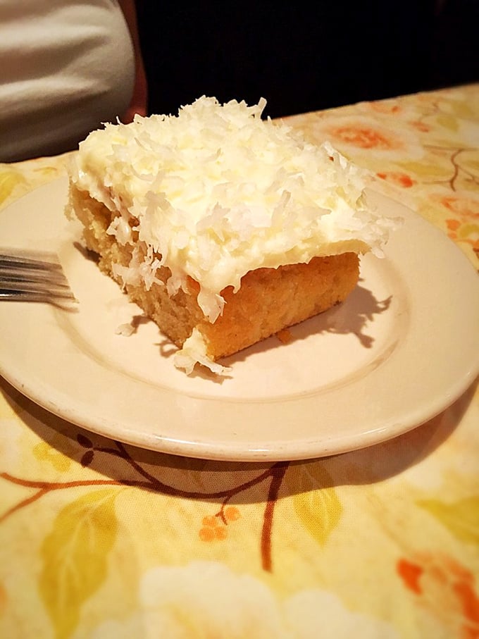 The coconut cake doesn't need fancy plating or edible flowers—it's the dessert equivalent of a perfect punchline, simple and utterly satisfying. 