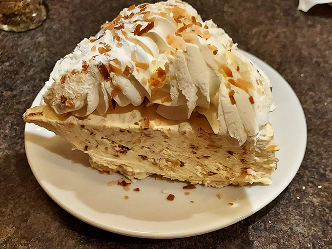 This coconut cream pie doesn't just end a meal—it provides closure, therapy, and a moment of pure bliss all in one towering slice.